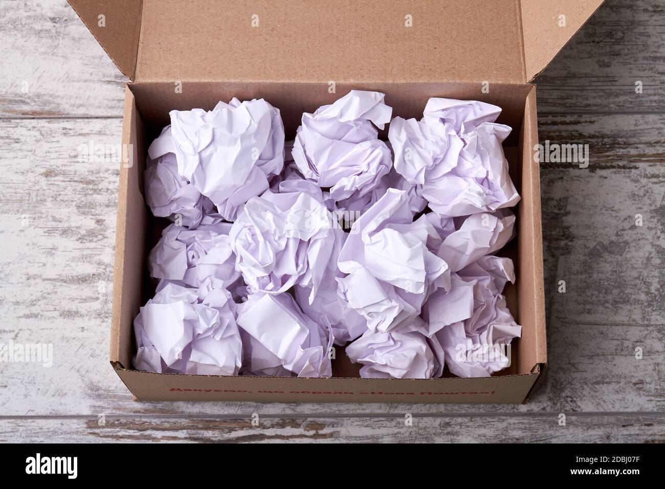 Crumpled paper balls filler in cardboard box Stock Photo - Alamy