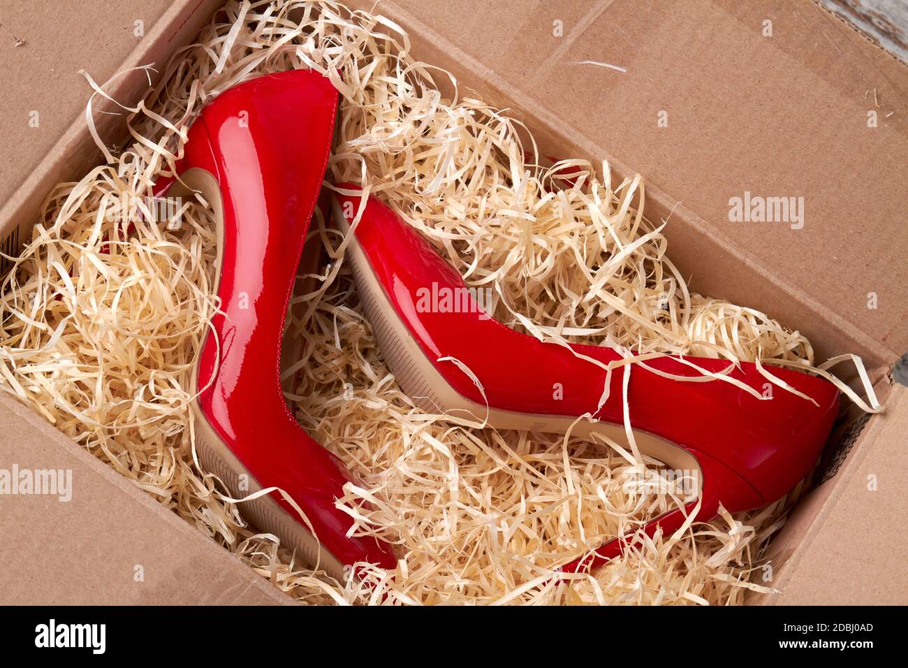 Stylish red shoes in cardboard box Stock Photo - Alamy
