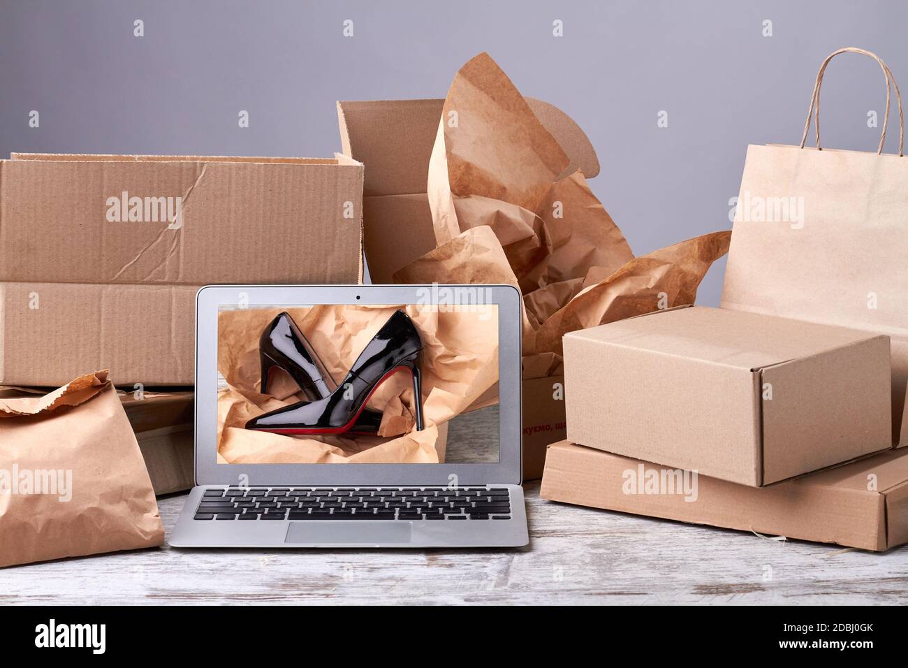 Cardboard box parcels and laptop on table Stock Photo - Alamy