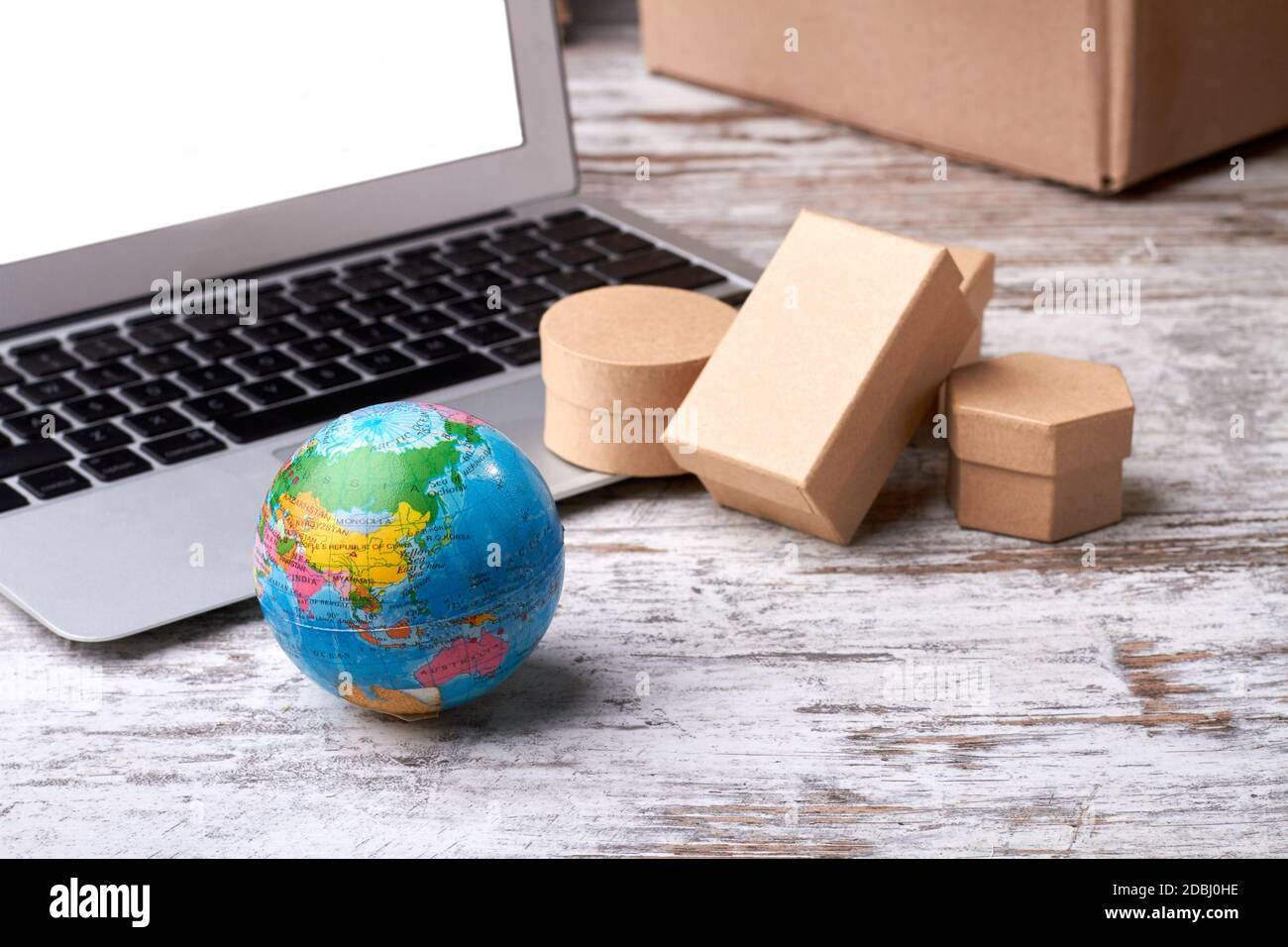 Packaging paper and shipping boxes on laptop Stock Photo - Alamy