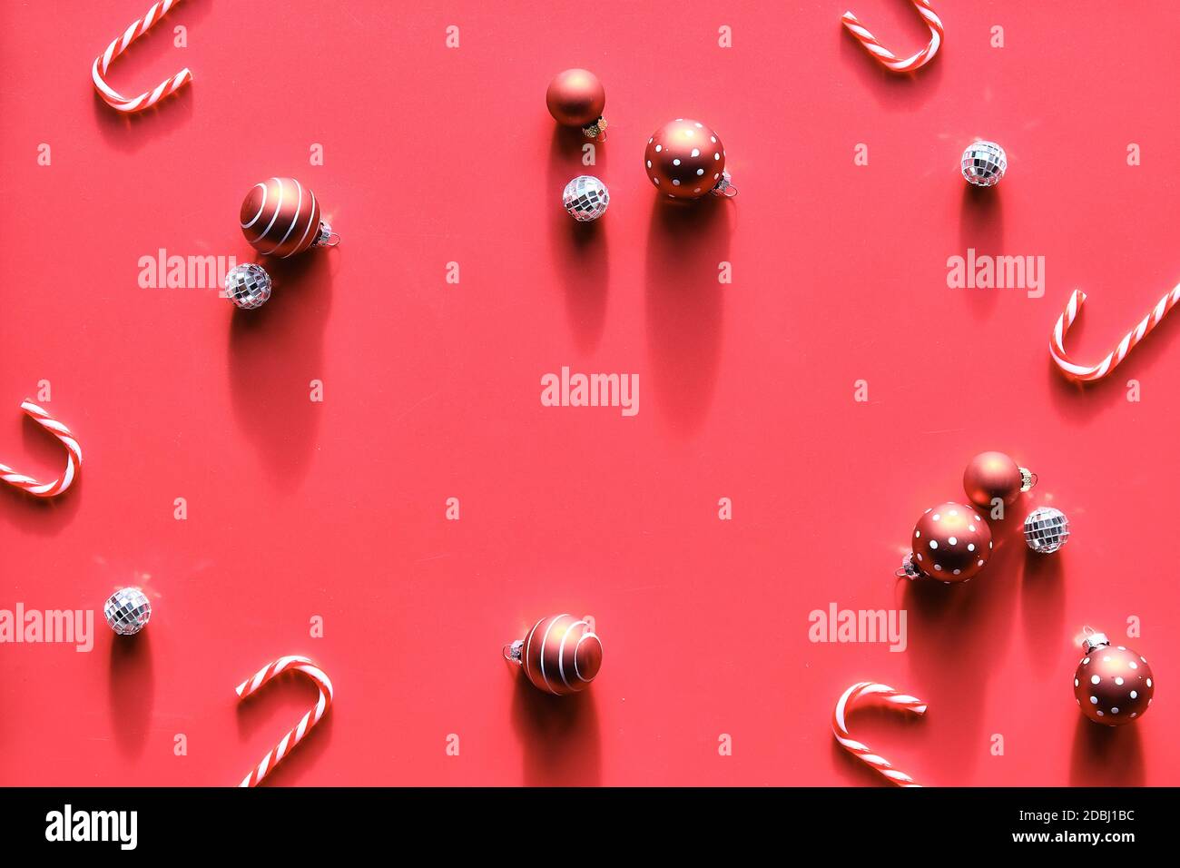 Flat lay with Xmas decorations - candy canes, disco balls and baubles ...