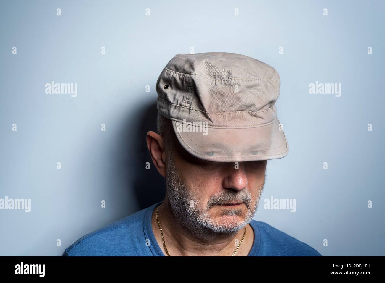 a look hidden under the cap Stock Photo - Alamy