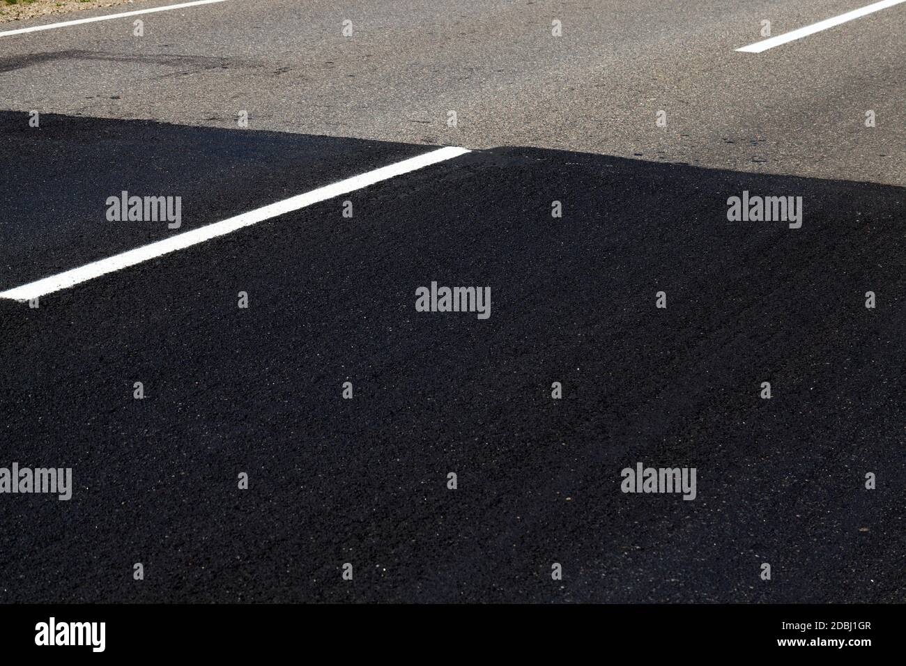 repaired part of the paved road, close-up after the repair of holes and ...