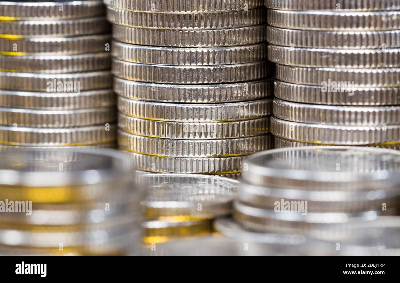 stack of old gold-lit coins, close-up of metal money with flaws and ...