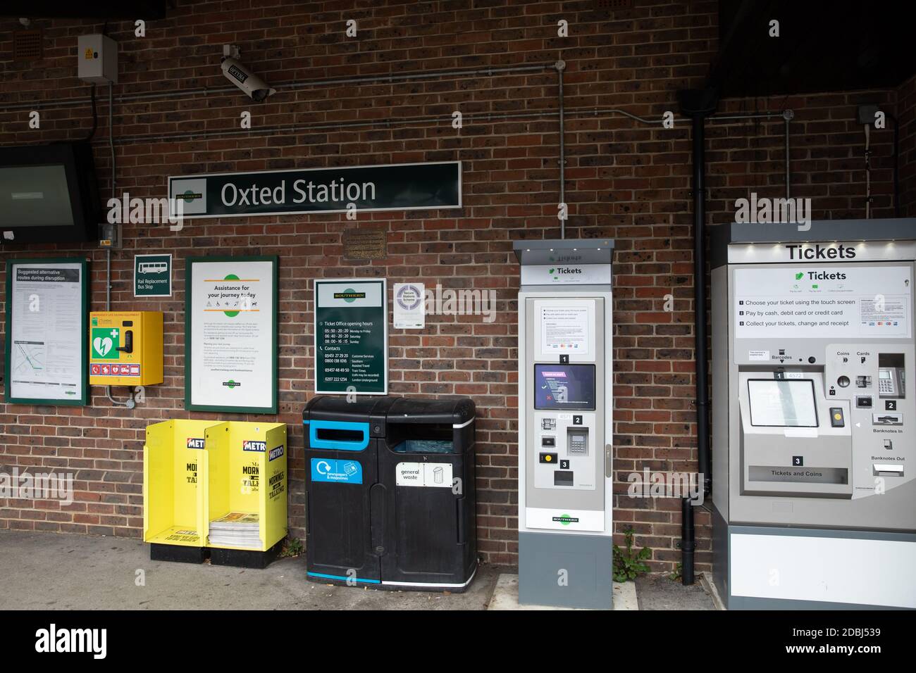 Ticket machines, rubbish bins and newspaper stand outside Oxted Station ...