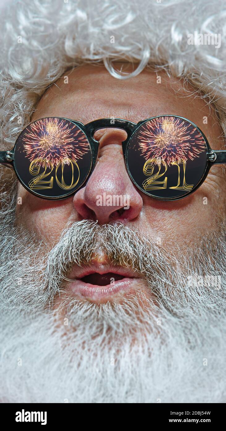 Close-up shot of Santa Claus in stylish glasses with a reflection of ...