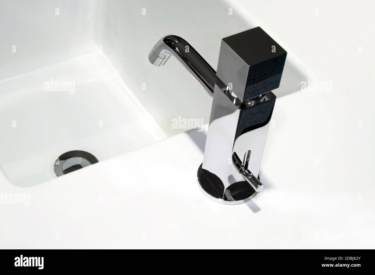 Contemporary silver faucet in simple geometric shape Stock Photo - Alamy