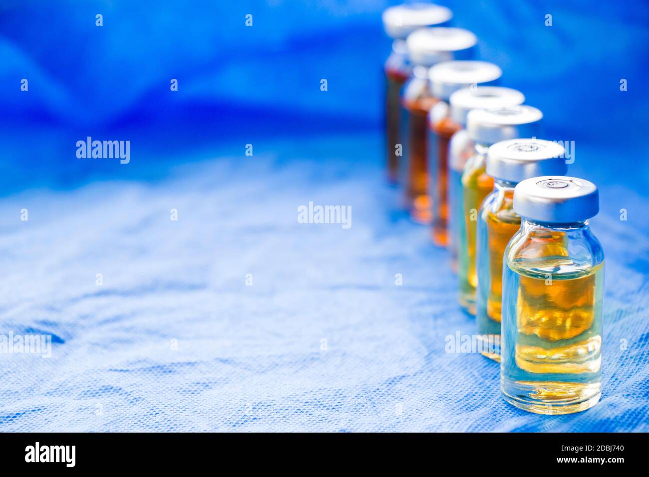 Corona virus and Covid - 19 new vaccine in ampules, different color ...