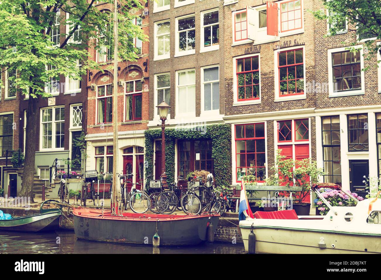 Traditional Dutch houses standing on the bank of the canal. Photo is ...