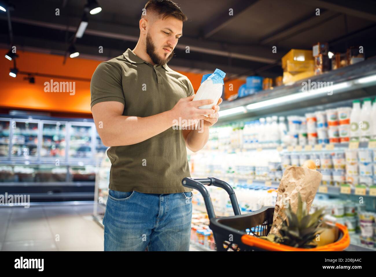 Man choosing milk in grocery store, dairy products department. Male ...