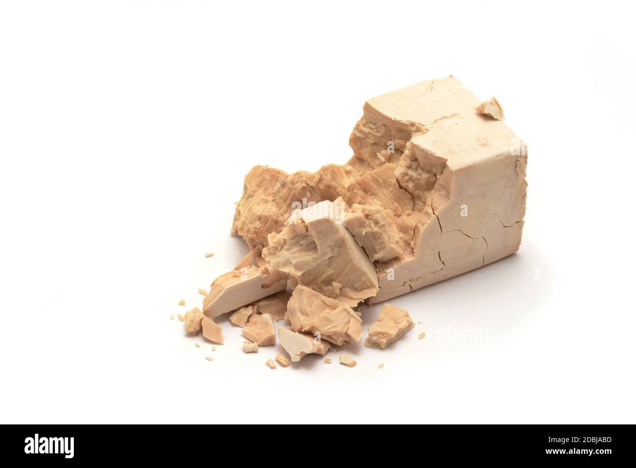 Crumbled fresh yeast block over white background Stock Photo - Alamy