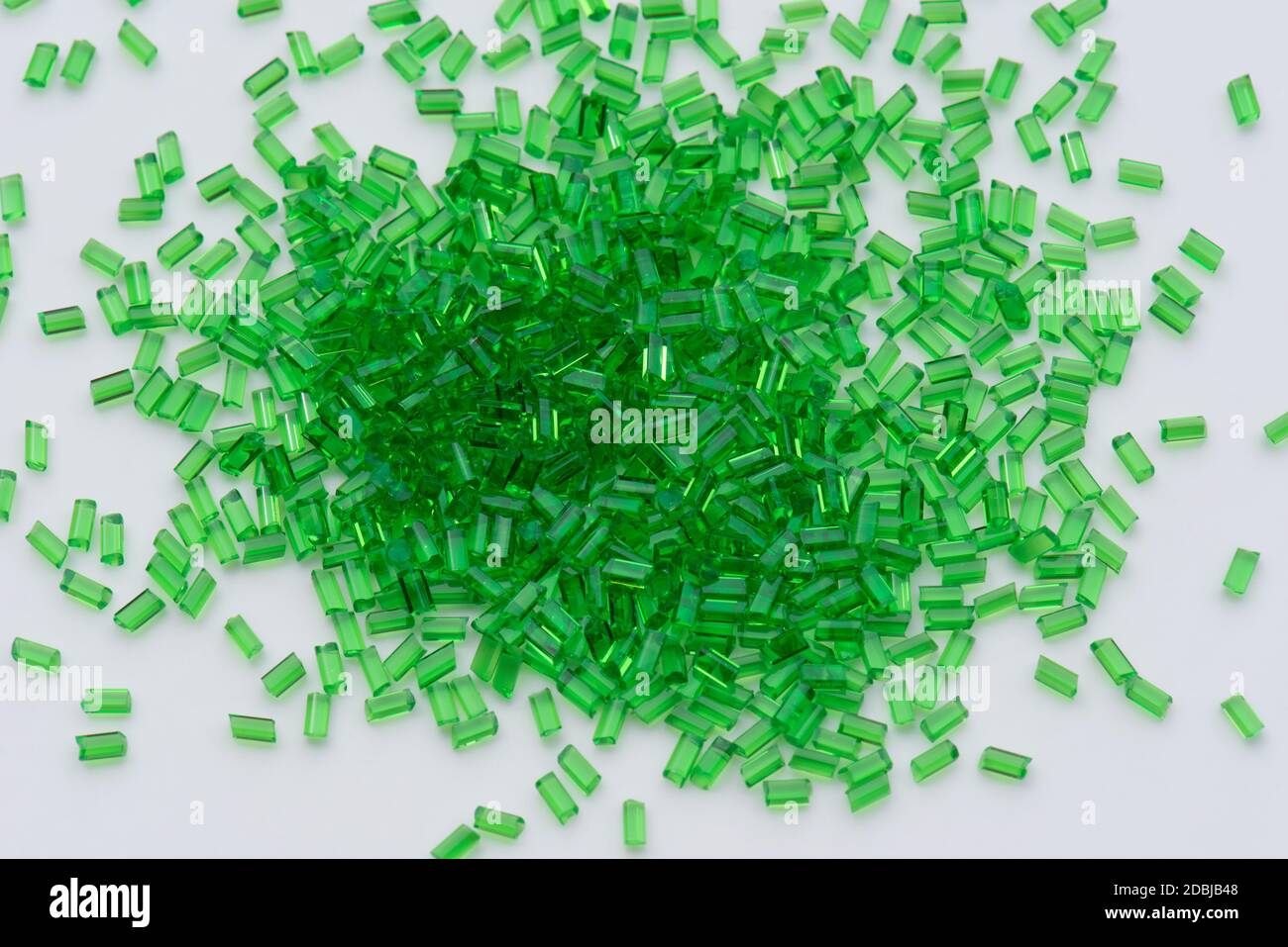 Green transparent polymer granulate on white background Stock Photo - Alamy