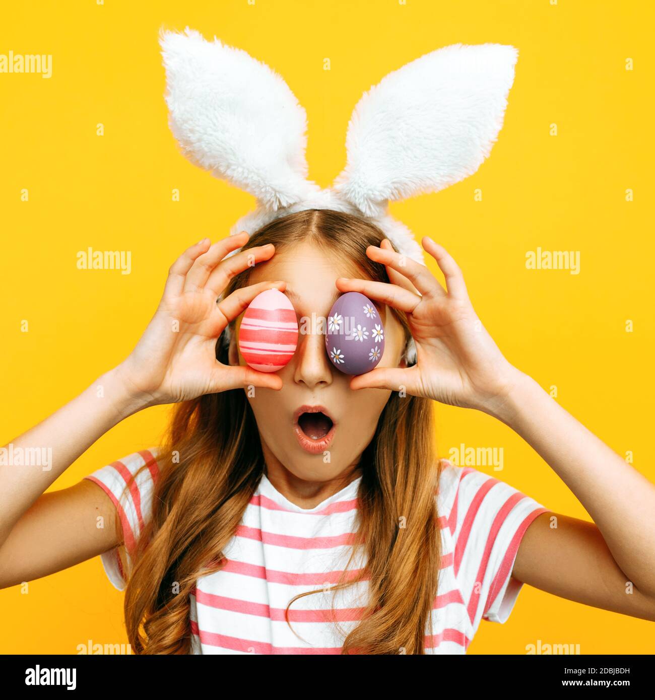 Shocked surprised beautiful girl on her head with rabbit ears and ...