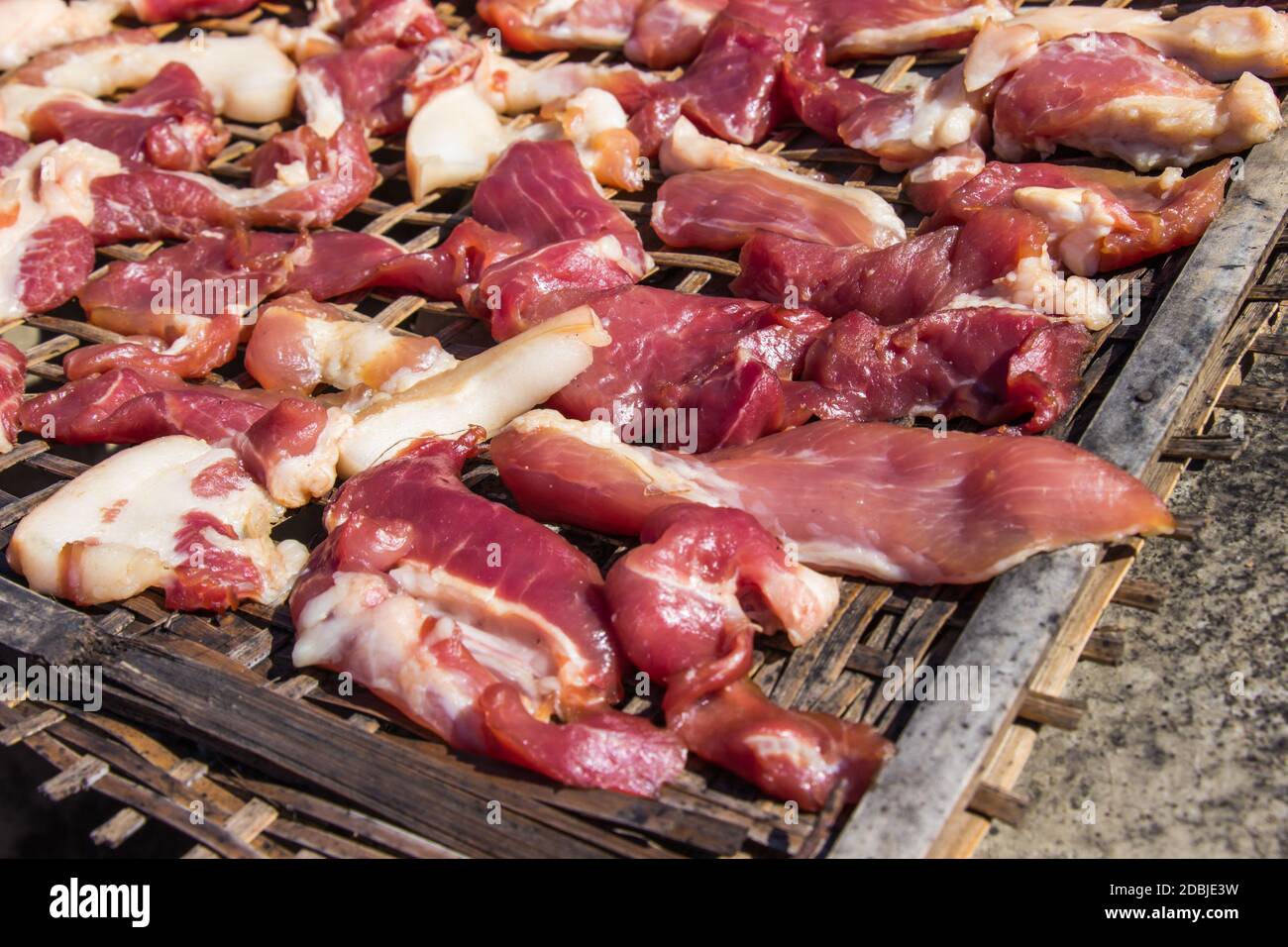 Preserving pork meat by dry with Sun-dried on bamboo basket weave palat ...