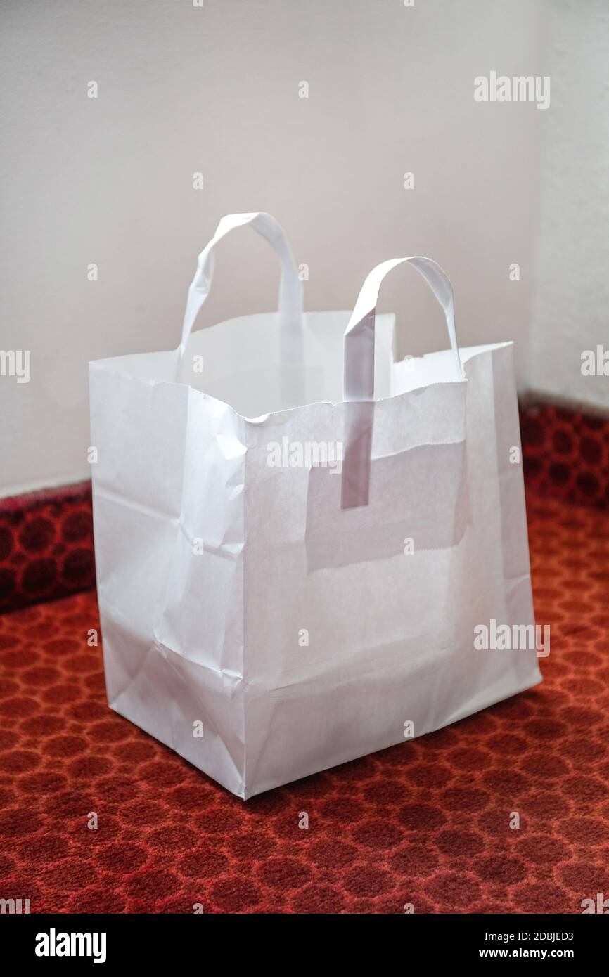 Big White Paper Shopping Bag at Floor Stock Photo - Alamy