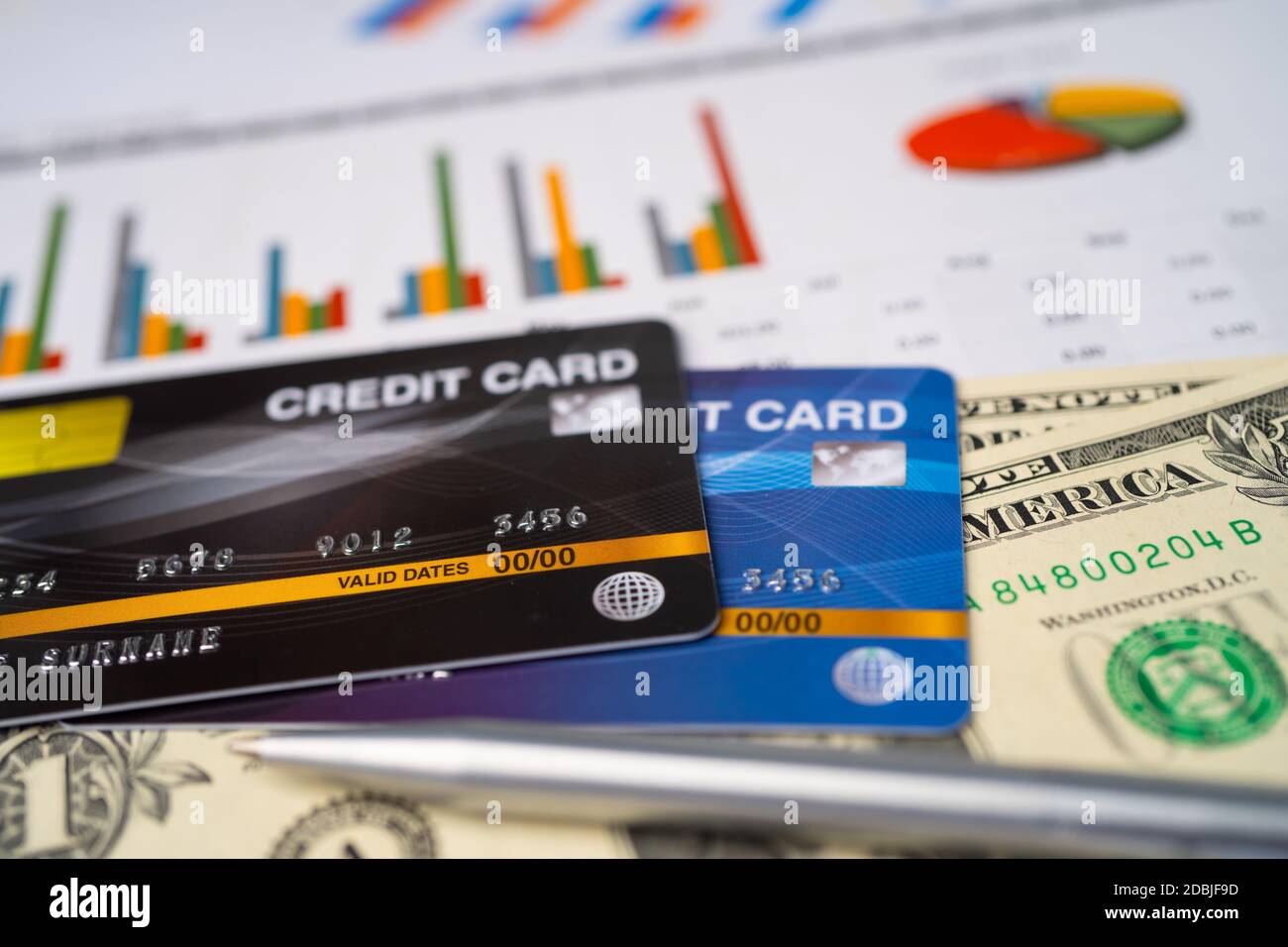 Credit card model on chart and graph paper. Finance development ...