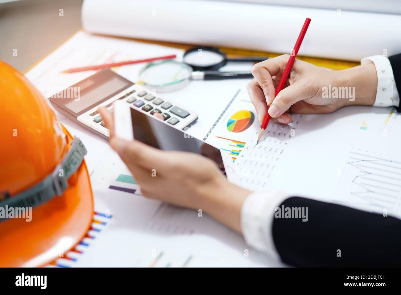 Architect or engineer working project accounting with graph with tools ...