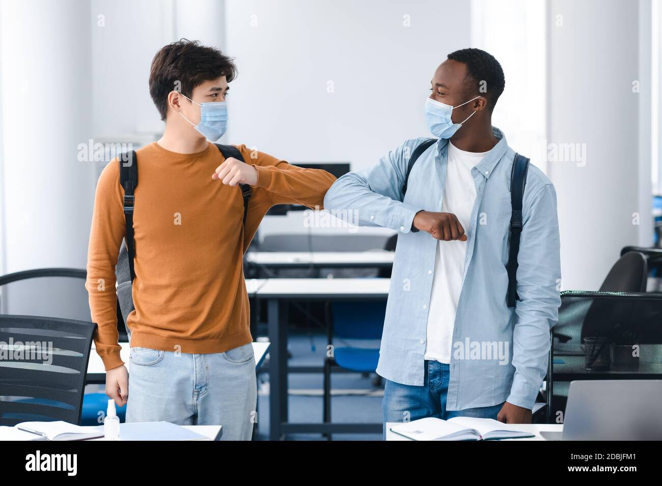Student bumping elbows hi-res stock photography and images - Alamy