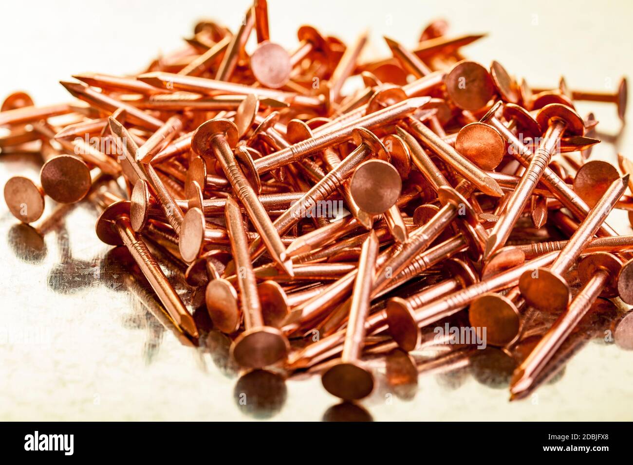 Pile of copper nails on a galvanized steel table Stock Photo - Alamy