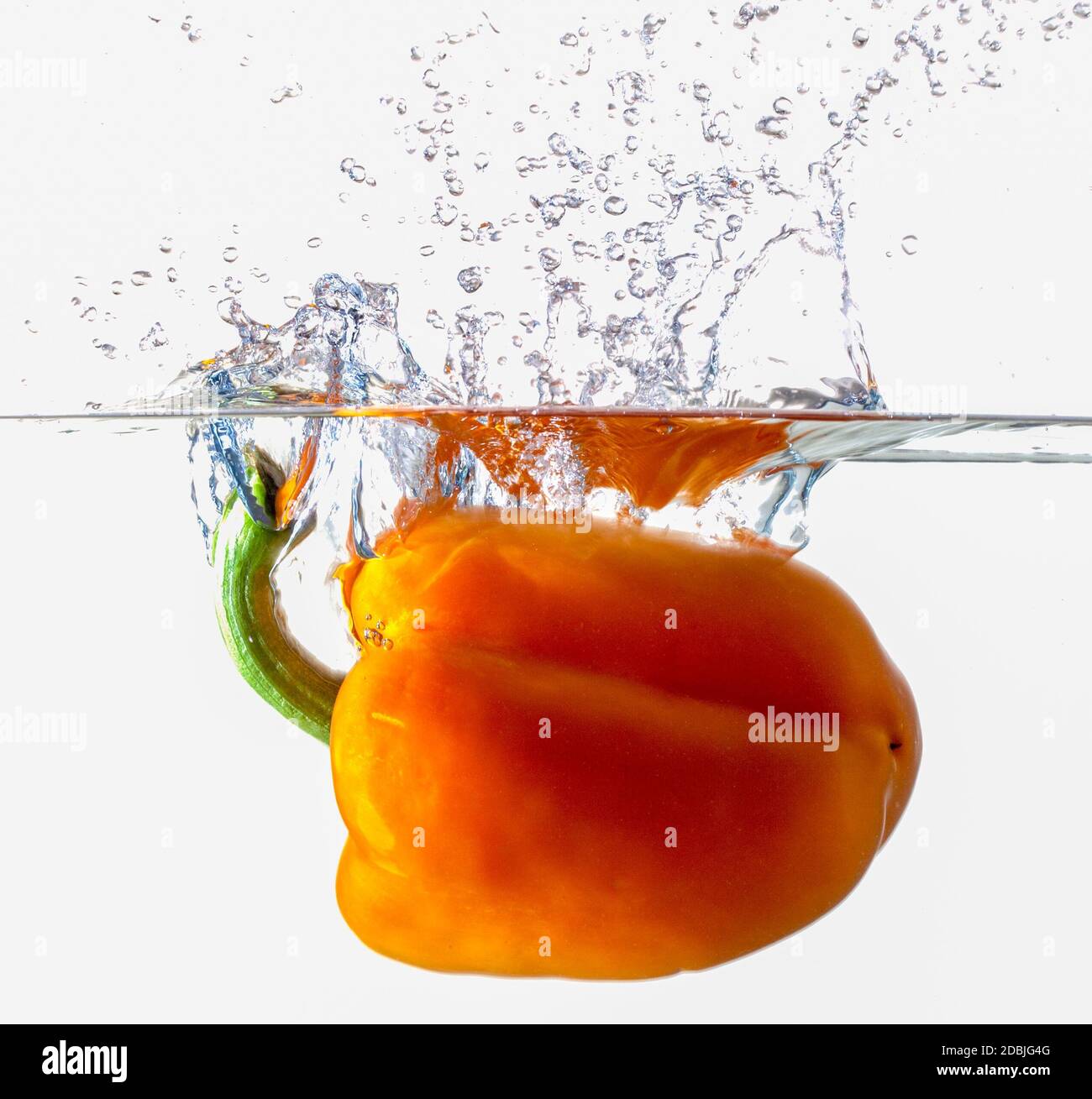 Orange Bell Pepper Dropping Into Water Stock Photo - Alamy