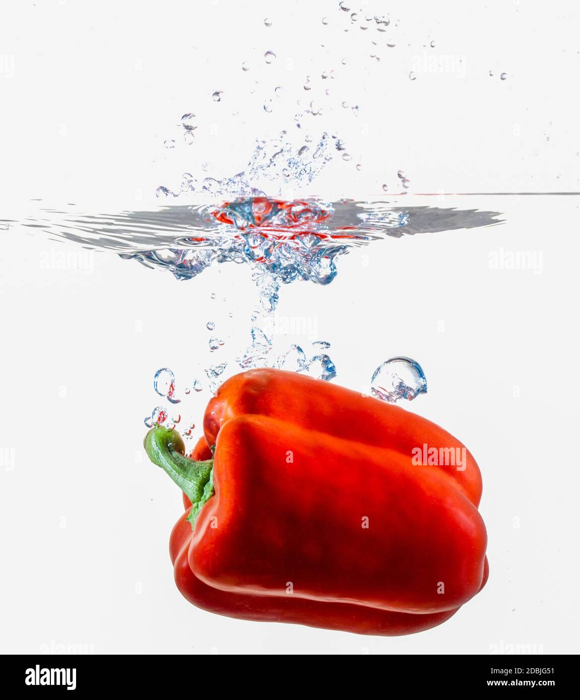 Red Bell Pepper Dropping Into Water Stock Photo - Alamy