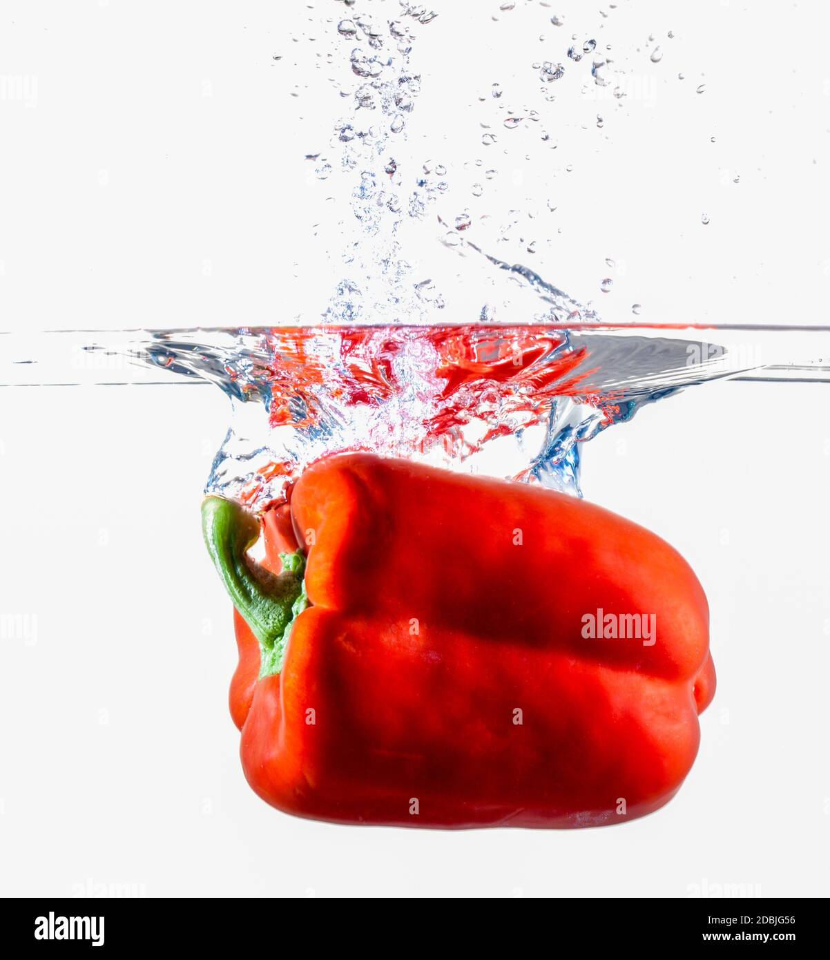 Red Bell Pepper Dropping Into Water Stock Photo - Alamy