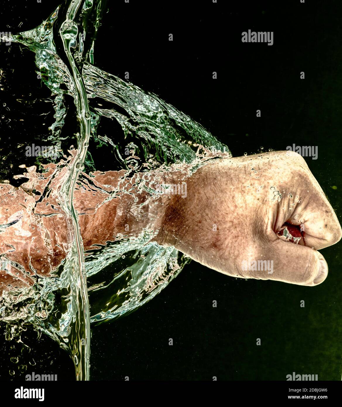 Punching Through Water - Close-up of a man s fist punching through ...