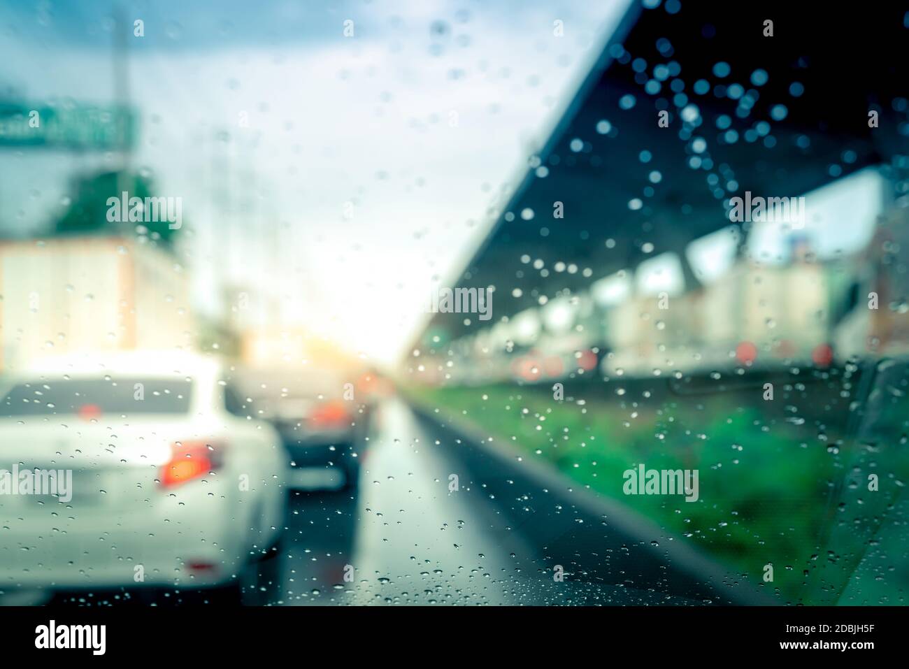 Rain drops on windshield. Car driving on asphalt road on rainy day ...