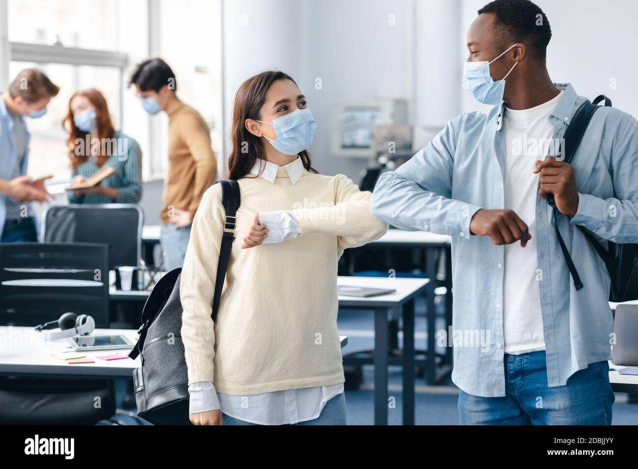 Student bumping elbows hi-res stock photography and images - Alamy