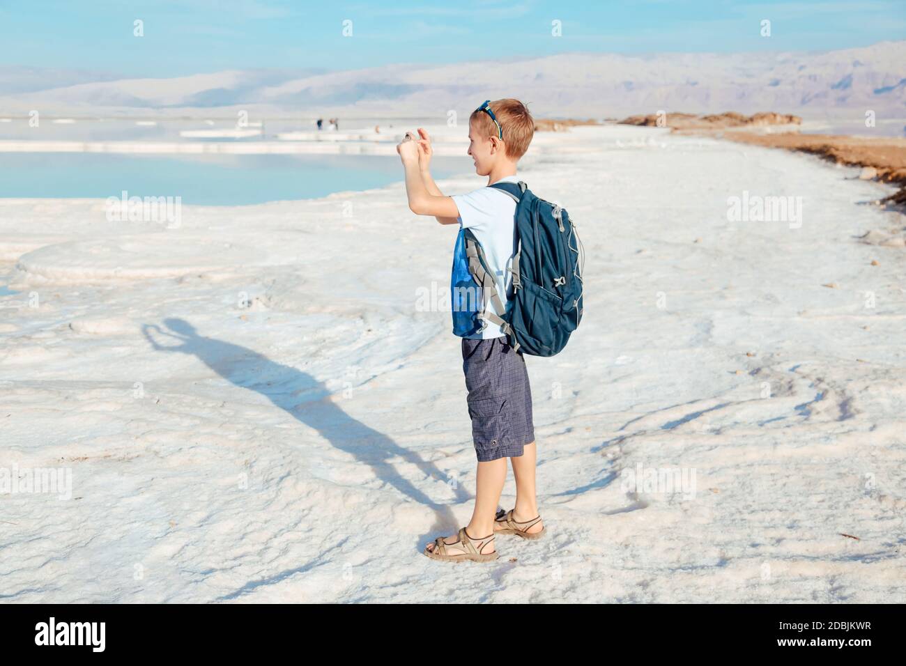 Blond boy enjoying bright day on Dead sea beautiful salt shore. Israel. Ein Bokek Stock Photo ...
