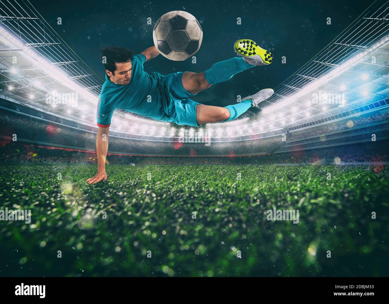 Soccer striker hits the ball with an acrobatic kick in the air at the ...