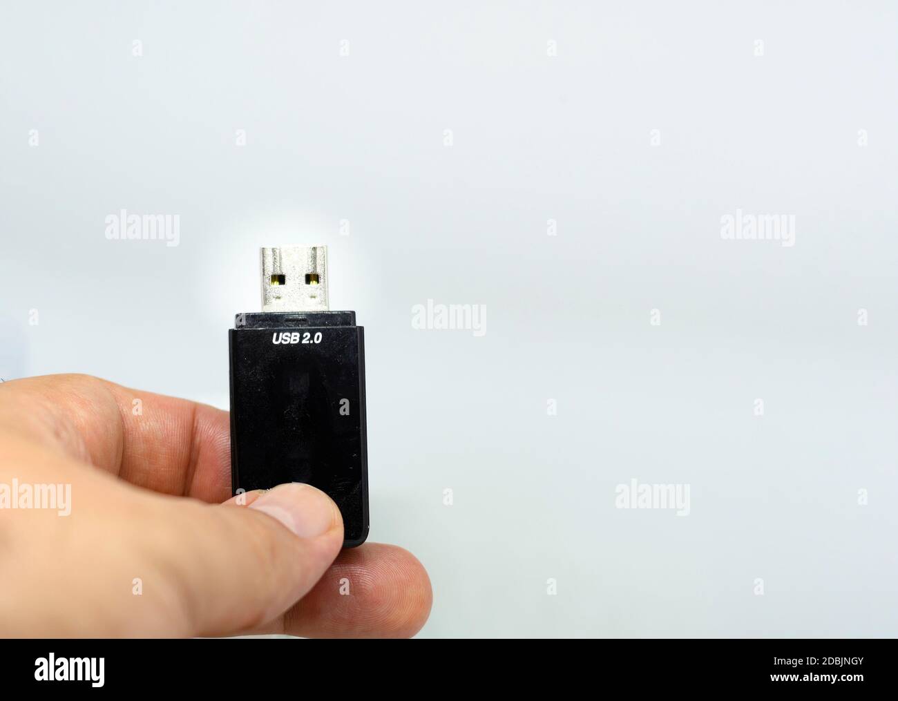 human male hand holding a USB flash memory on a white background ...