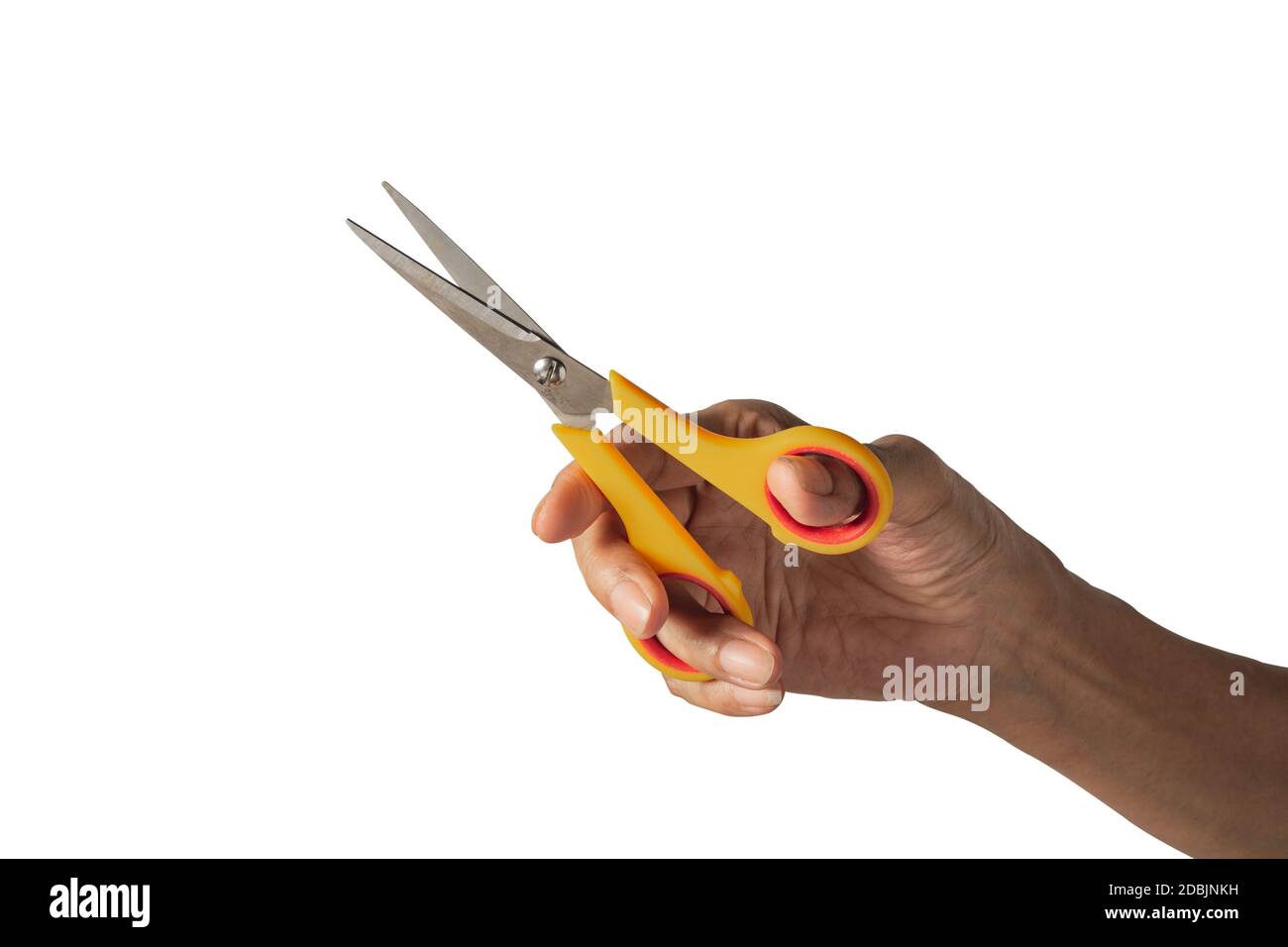 Hand holding a scissors with yellow plastic handle and clipping path ...