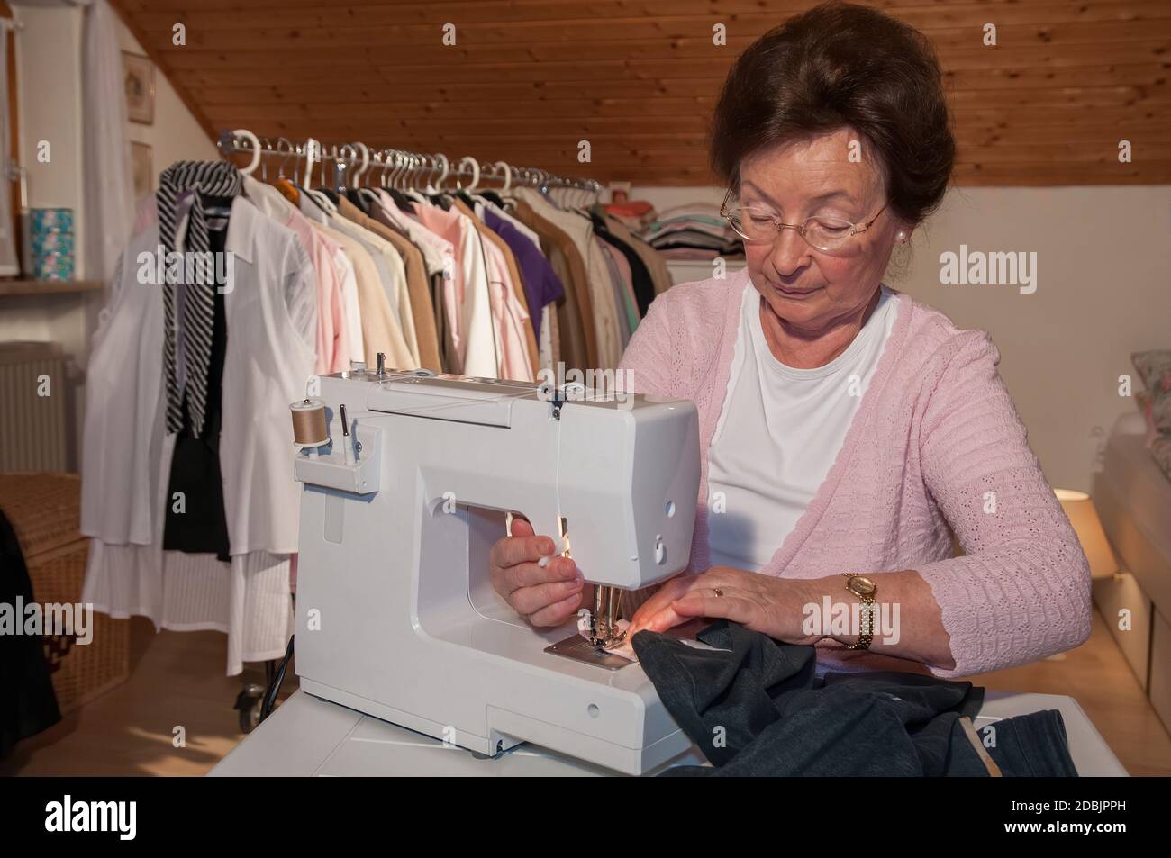 Senior woman sewing with sewing machine Stock Photo - Alamy