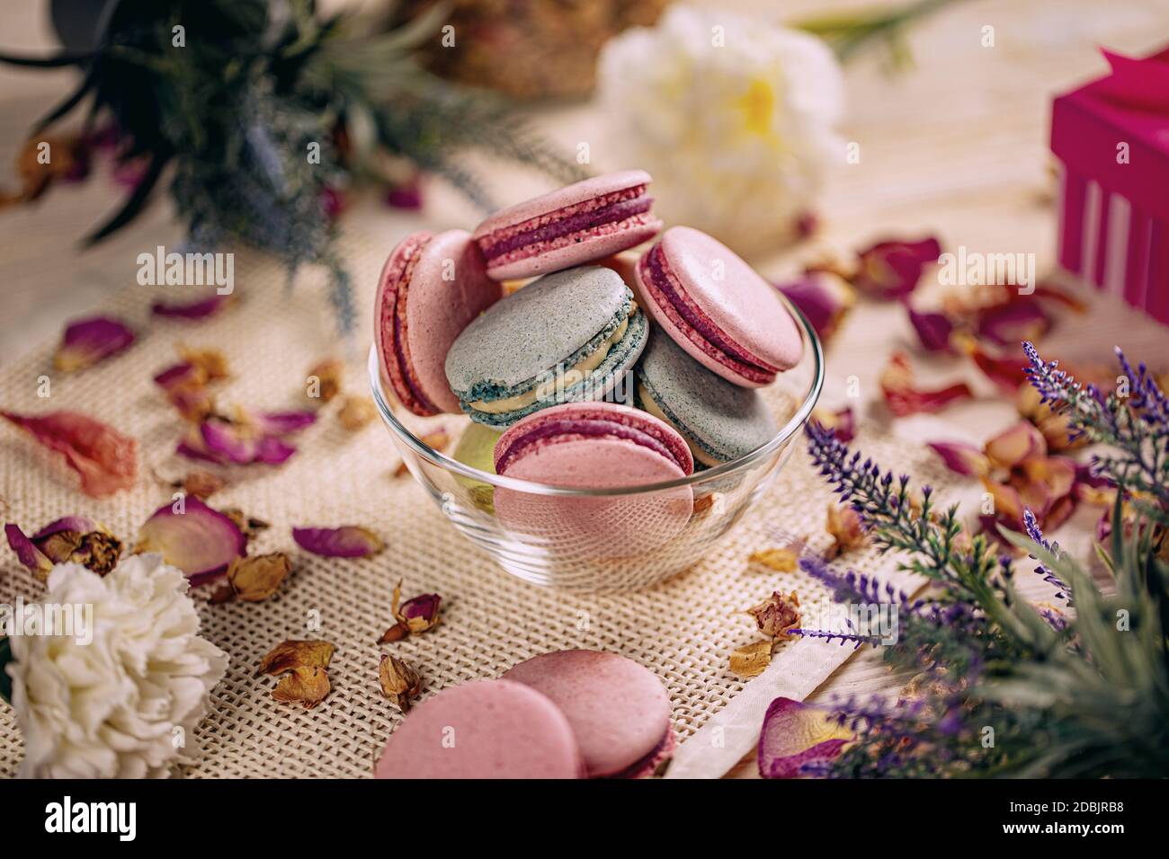 Different types of macaroons in glass bowl, still life Stock Photo - Alamy