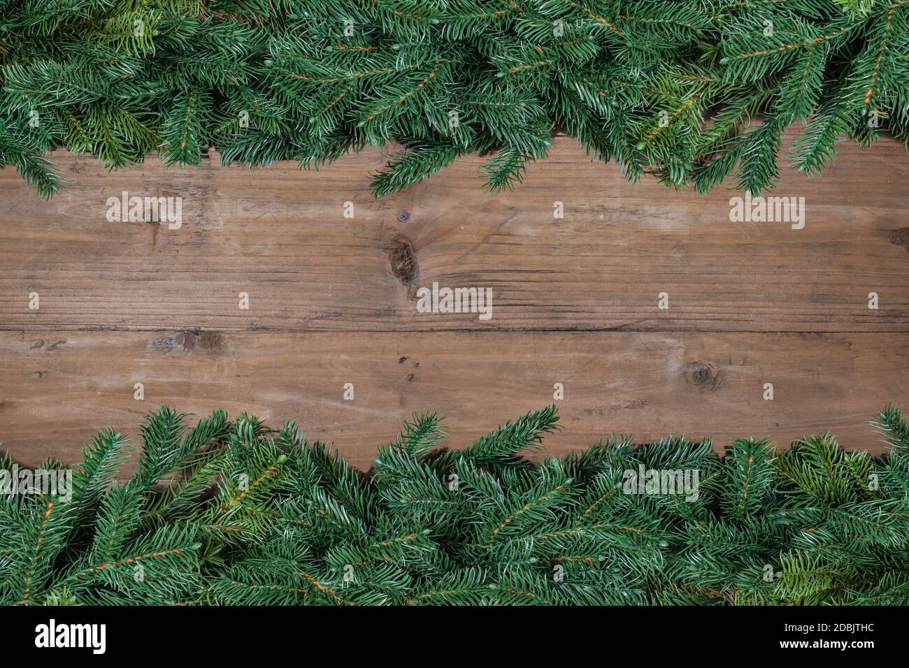 Christmas tree branch borders on wood background Stock Photo - Alamy