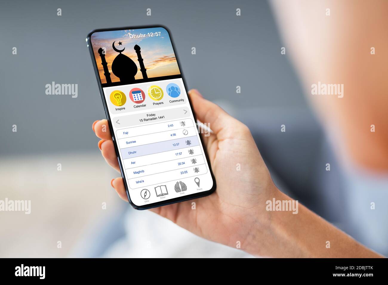Woman Using Muslim Prayer App On Mobile Phone Stock Photo - Alamy