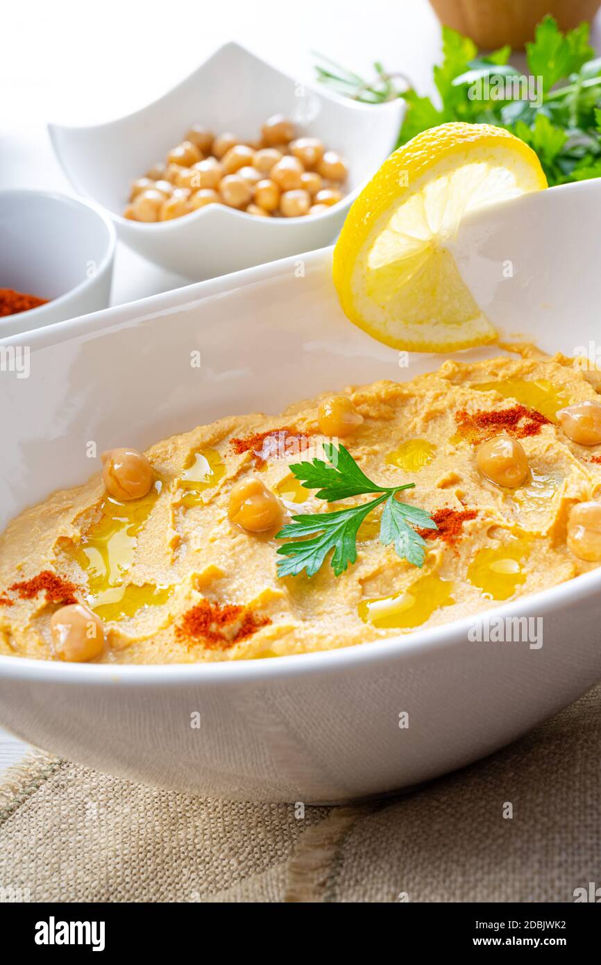 hummus paste with lemon and chilli on white background Stock Photo - Alamy