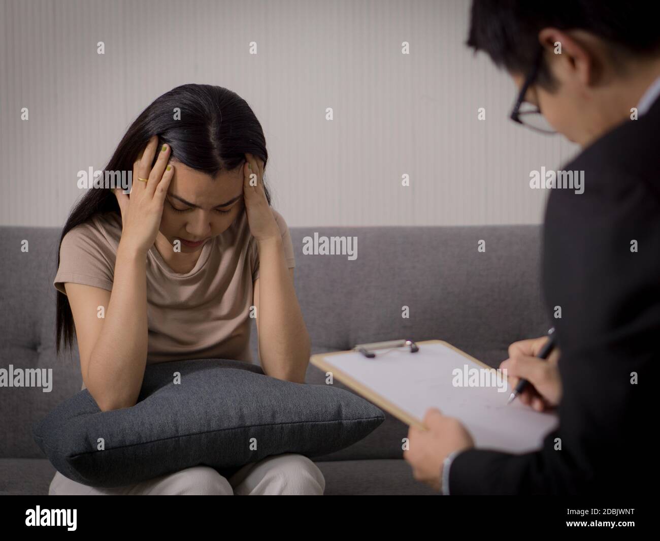 Sad woman with depression having consultation with psychiatrist in ...