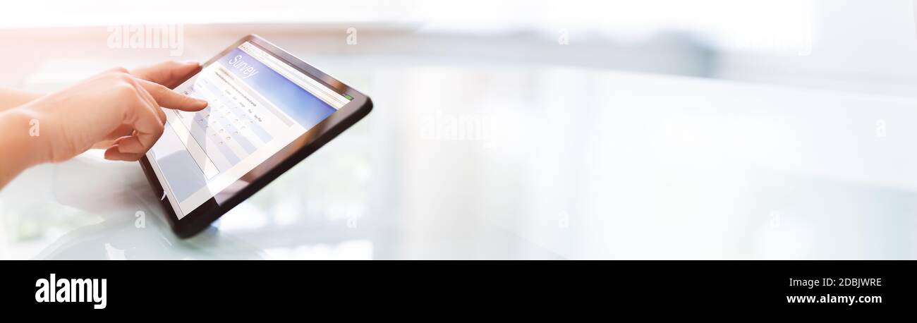 Filling Online Survey Form Or Questionnaire Poll On Tablet Stock Photo ...