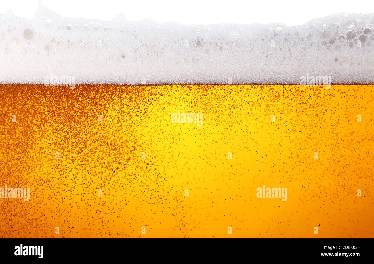 Close up background texture of lager beer with bubbles and froth in ...