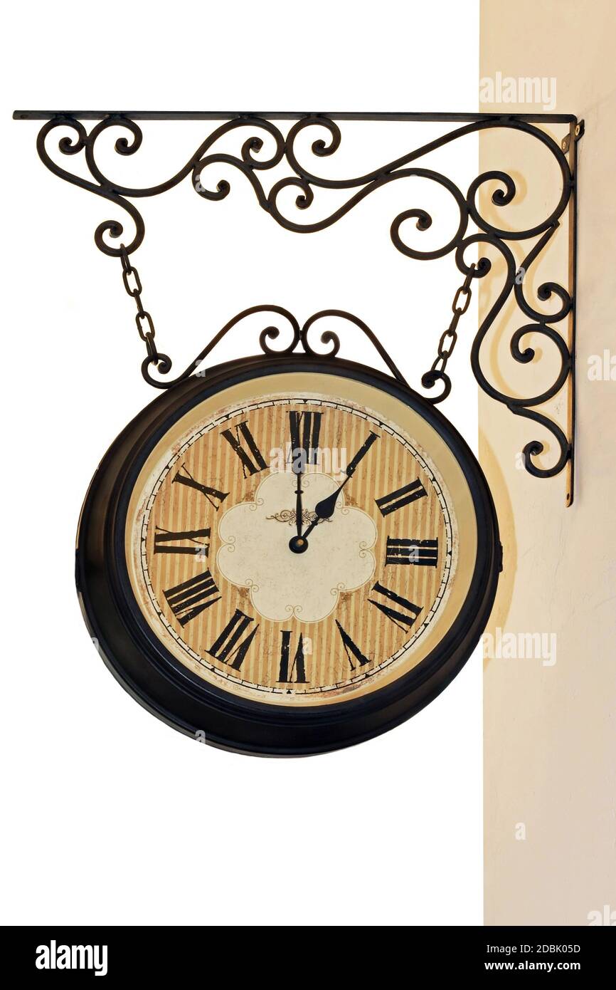 Old style hanging clock with iron work Stock Photo - Alamy