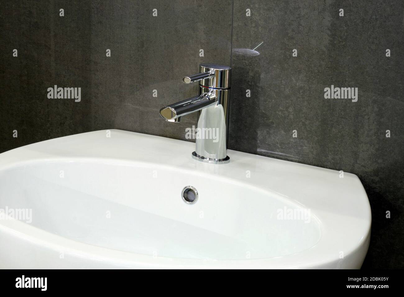 Water pipe silver faucet and white basin Stock Photo - Alamy