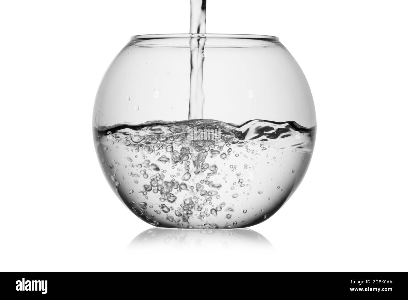 Splash jet of water pours in glass fishbowl with bubbles isolated on a ...