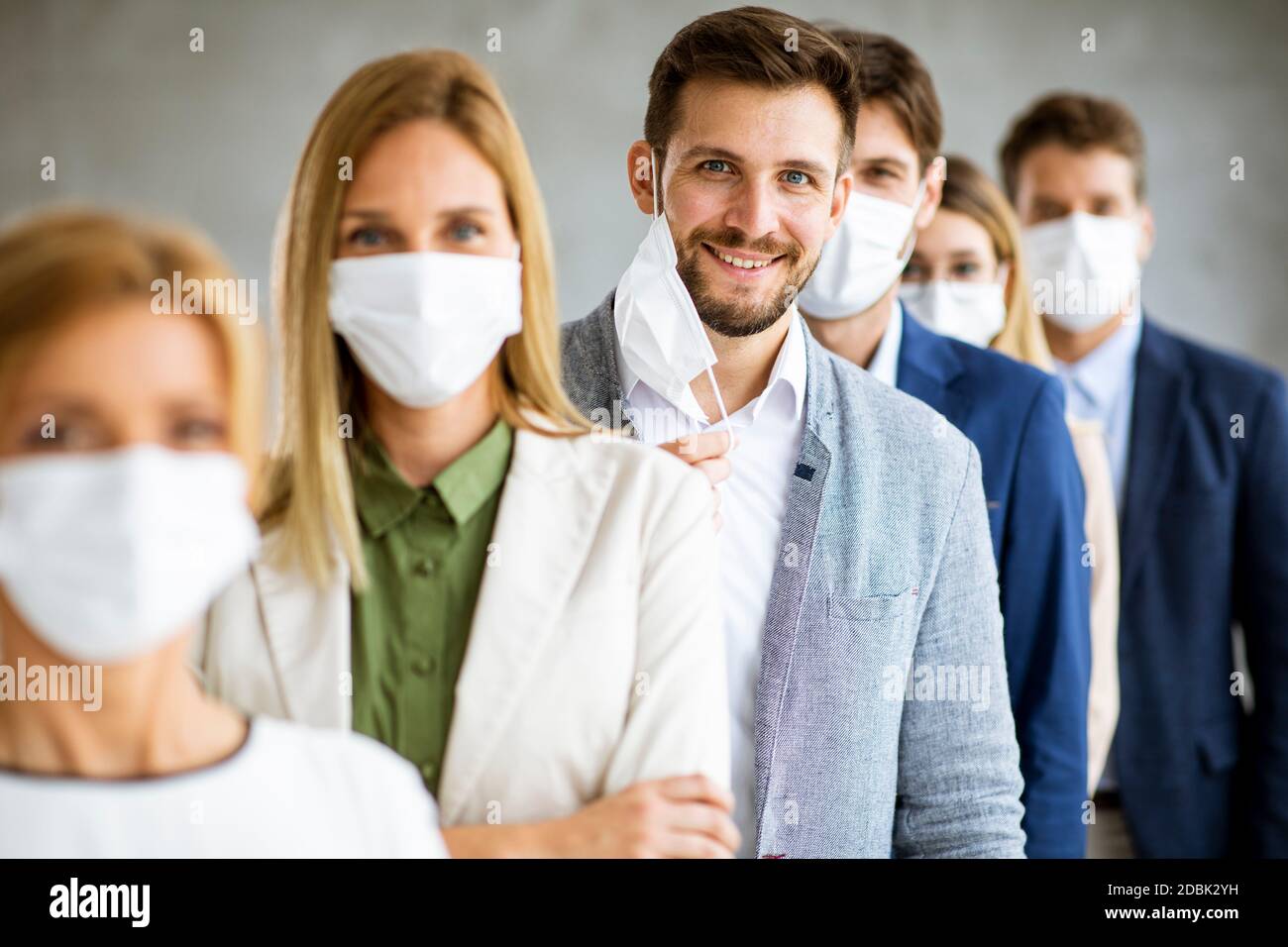 Business man taking off hisprotective facial mask and looking at the ...