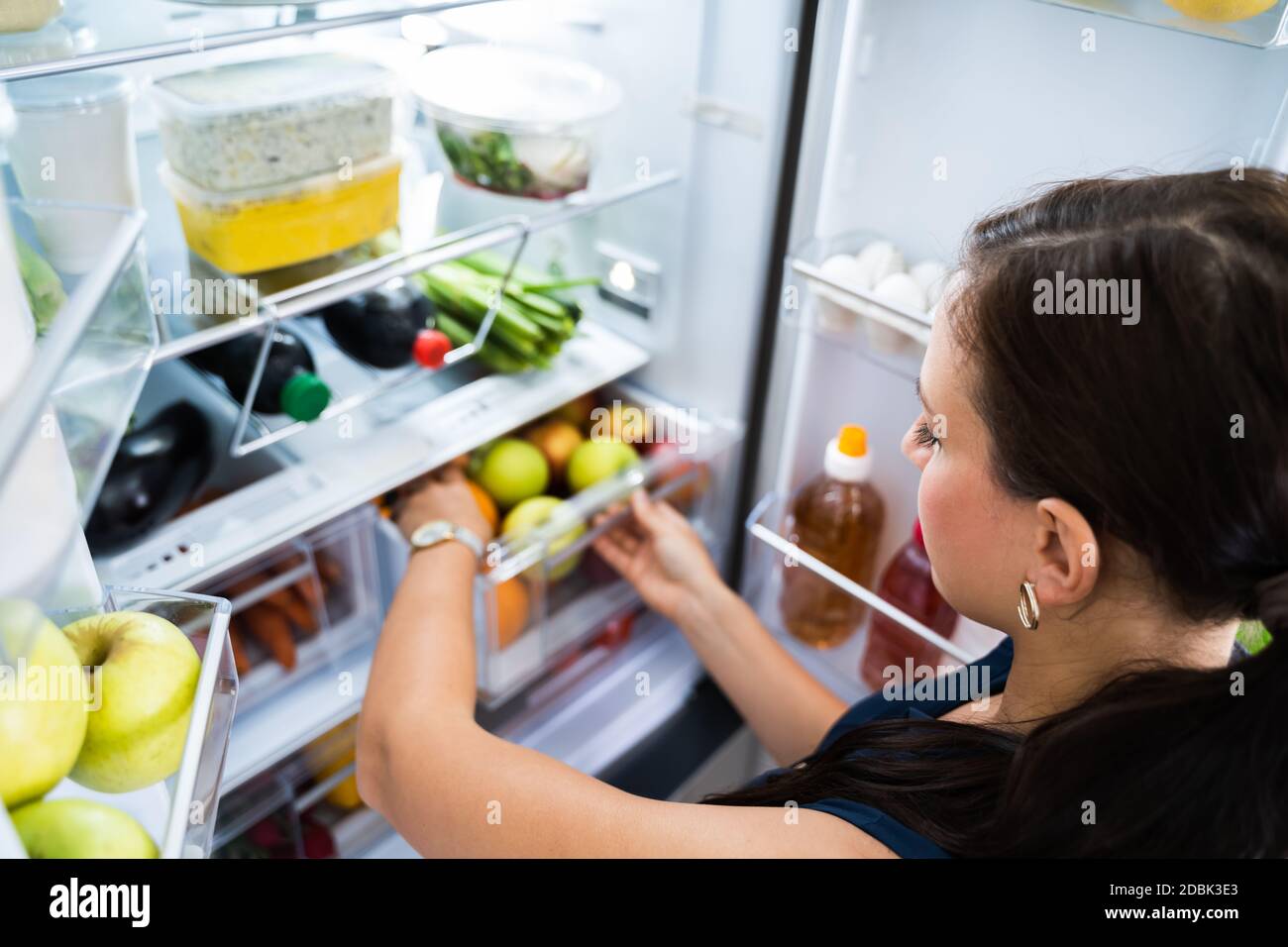 Women Looking For Food Inside Fridge In Kitchen Stock Photo - Alamy