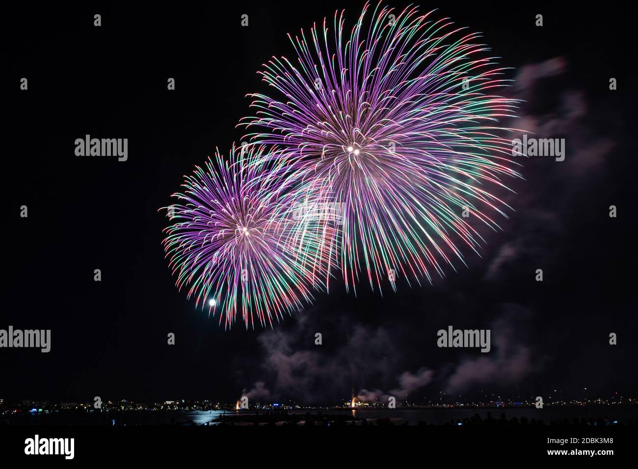 Scenic fireworks glowing in the night for the 14th of July celebrations ...