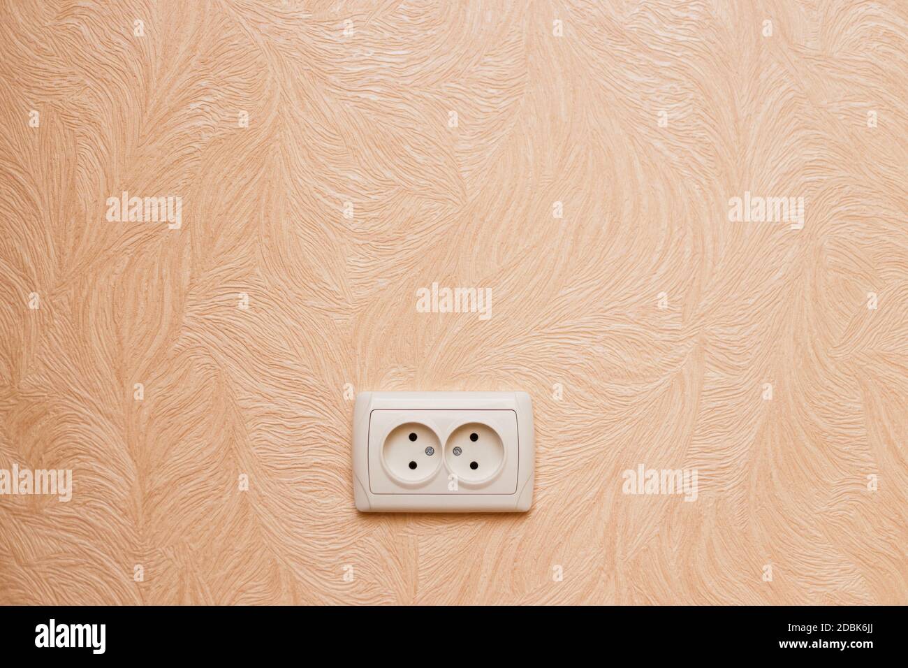 European electric outlet on wall covered with wallpaper Stock Photo - Alamy