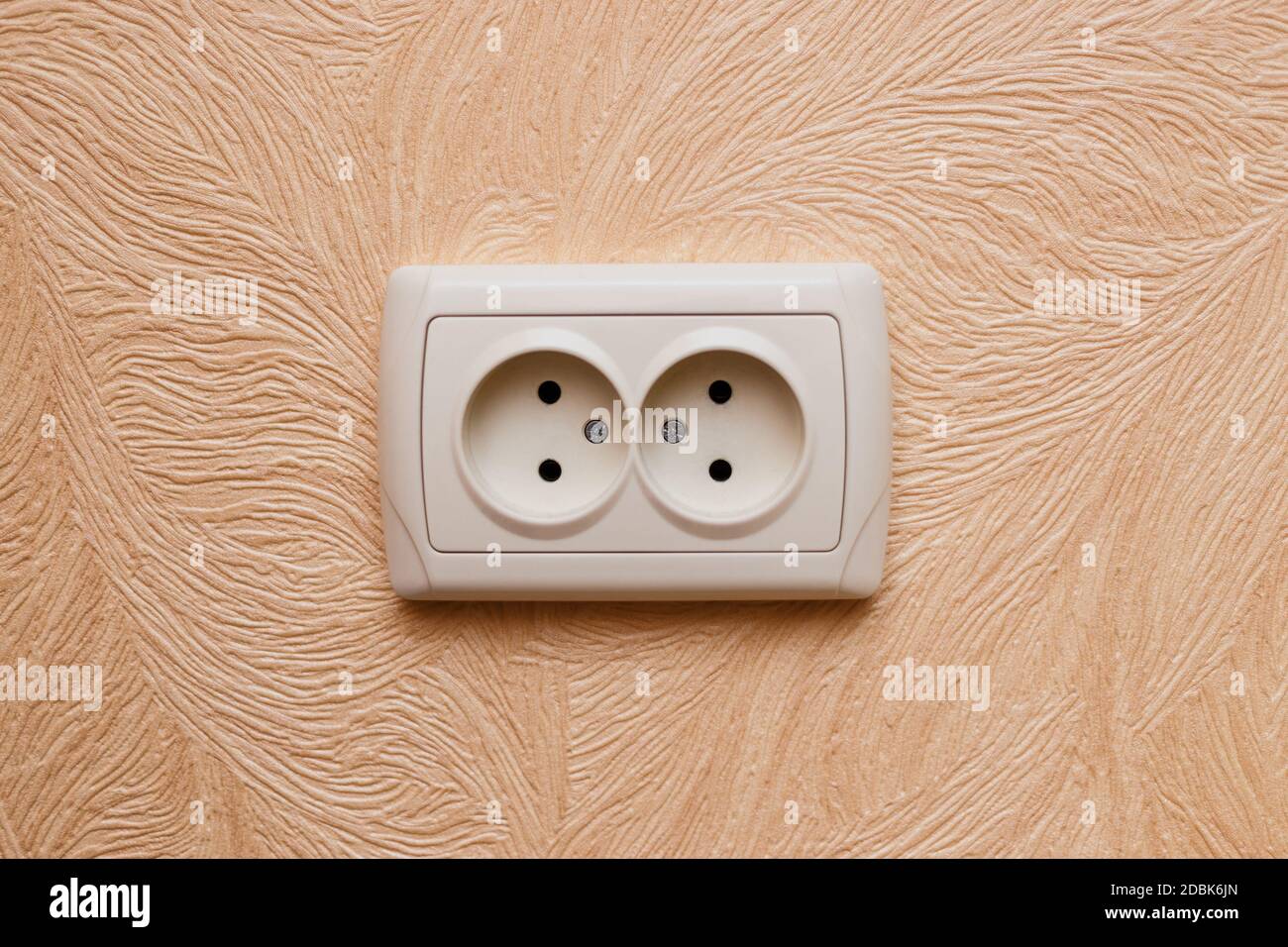 European electric outlet on wall covered with wallpaper Stock Photo - Alamy