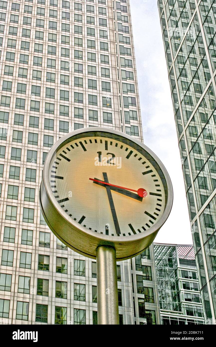 Public clock in front of business building Stock Photo - Alamy